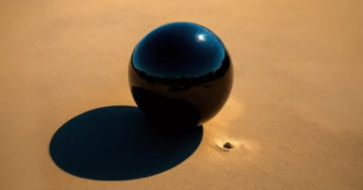 Lexica - A perfectly round black orb on the sand