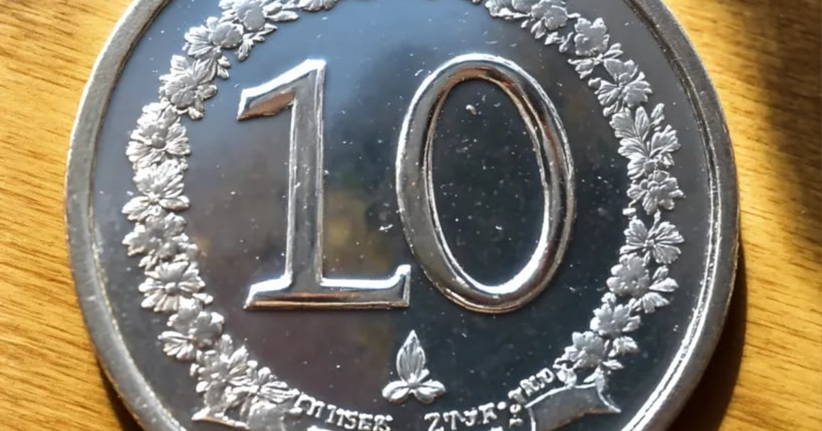 Lexica - A silver round silver coin with the number 10 stamped in the ...